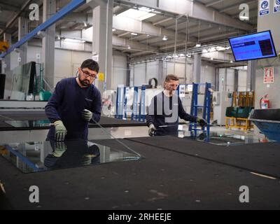Factory for windows and car Windshield production. Manual worker ...