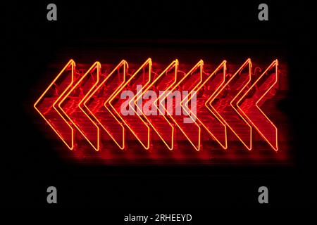 Set of red arrows neon light pointing down Stock Photo - Alamy