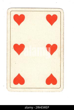 An antique six of hearts playing card isolated on a white background ...