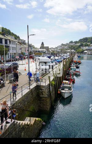 Looe, UK - August 2023: View of harbour and arched bridge over East ...