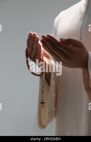 Praying Muslim man with Koran on white background Stock Photo - Alamy