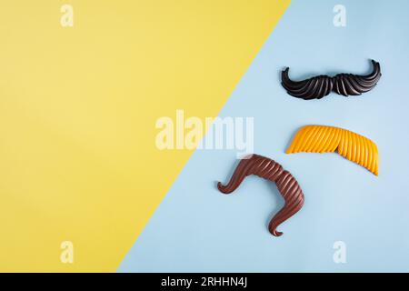 Curly mustaches on colorful background. Fake mustache. Top view Stock ...