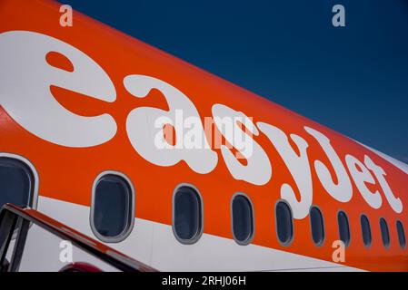 An EasyJet aeroplane in its distinctive white and orange livery taxiing ...