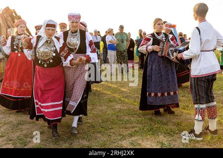 Locals in traditional seto estonian folk costumes dancing, celebrating ...