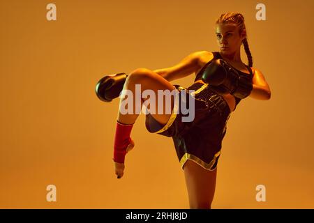 Strong legs. MMA fighter, teen girl training, kicking with leg against ...