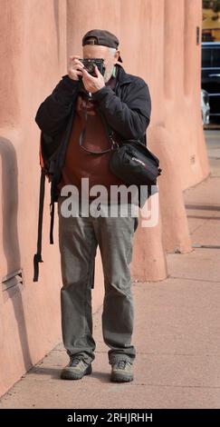 A photographer takes photographs with a Leica camera in downtown Santa ...