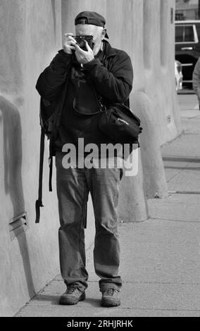 A photographer takes photographs with a Leica camera in downtown Santa ...
