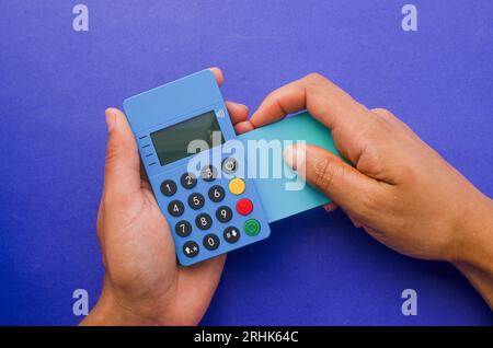Hands holding a portable contactless payment device, An ultra-light and ...
