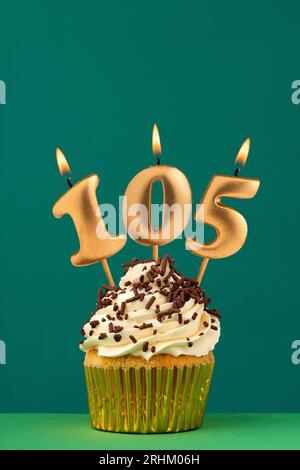 Birthday candle number 105 - Anniversary cupcake on black background ...