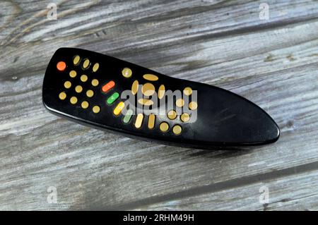 An old used remote control or a clicker, an electronic device used to ...