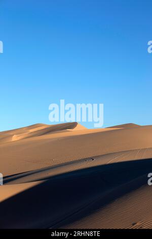 Sand dunes with wheel ruts and patterns in sand vertical Stock Photo ...