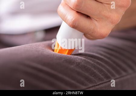 Auto Epinephrine Injector. Patient Doing Leg Injection Stock Photo - Alamy