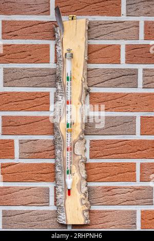 Old thermometer in wooden socket on a house wall, measure temperature ...