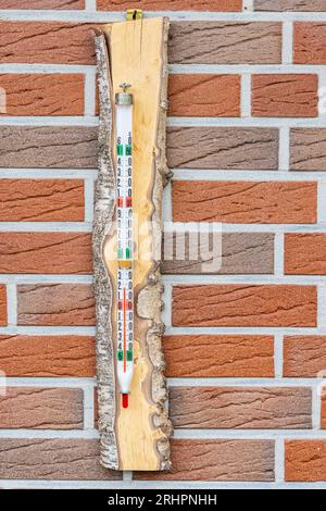 Old thermometer in wooden socket on a house wall, measure temperature ...