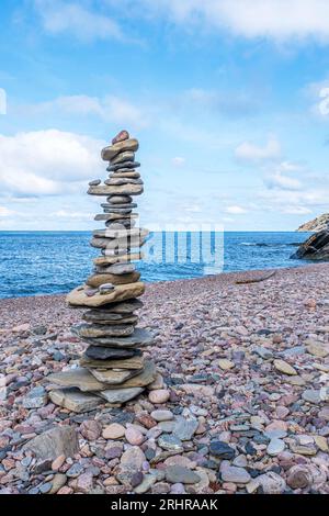 Visitors created an impromptu sculpture by balancing and stacking beach ...