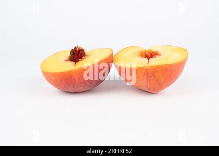 Sliced half peach with pit white background Stock Photo - Alamy
