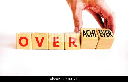 Achiever or overachiever symbol. Businessman turns wooden cubes and ...