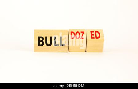 Bull or bulldozed symbol. Businessman turns wooden cubes and changes ...
