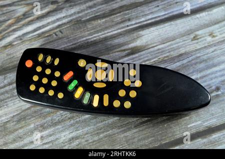 An old used remote control or a clicker, an electronic device used to ...
