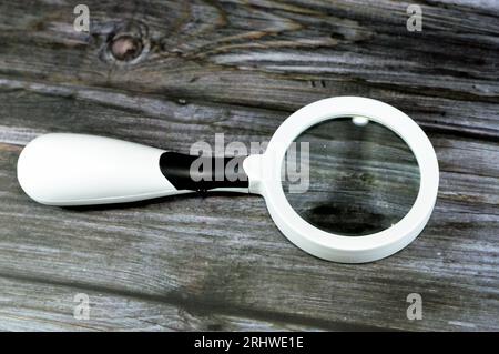 A magnifying glass, a convex lens that is used to produce a magnified ...