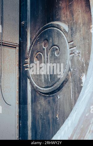 Close view of decorative element of wooden handmade chair on white wall ...