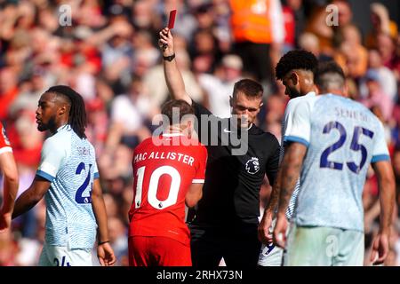 Referee Thomas Bramall shows a red card to Portsmouth's Marlon Pack ...