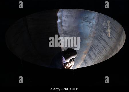 Prayagraj, India. 19th August 2023, A welder constructs a pontoon of ...
