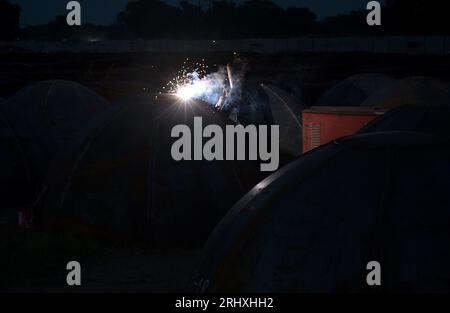 Prayagraj, India. 19th August 2023, A welder constructs a pontoon of ...