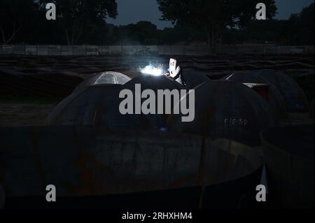 Prayagraj, India. 19th August 2023, A welder constructs a pontoon of ...