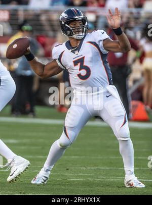 Denver Broncos quarterback Russell Wilson (3) turns to hand the ball ...