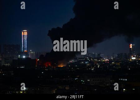 a factory catched a fire with lots dark smoke Stock Photo - Alamy