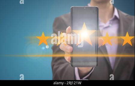 Please rate us banner wtih customer hand give five golden stars Stock ...