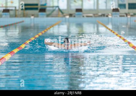 Female competitive swimmer moving through the water performing the ...