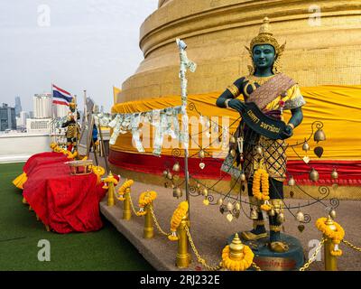 Captured up close, a statue rests beneath the temple's gilded spire ...