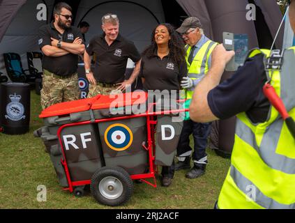 An elderly municipal bin man with his bins painted in the military ...