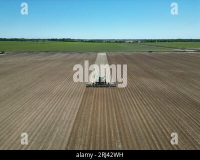 A closeup of a professional mechanism Preparing rows for cotton ...