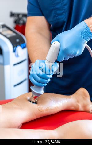 Physical therapy of the shin with shock wave, extracorporeal shockwave ...