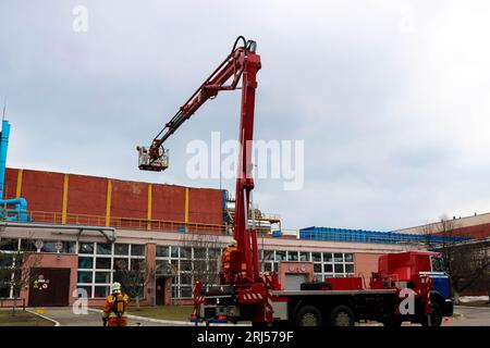 Firefighter rescuers at work in fireproof suits came to extinguish a ...