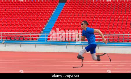An Asian paralympic athlete equipped with prosthetic running blades ...