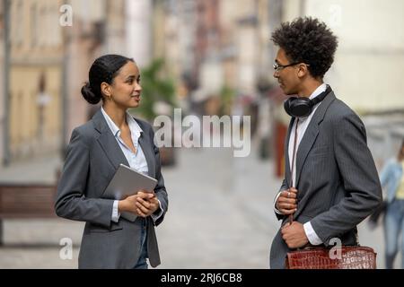 Friends going home after work and discussing something Stock Photo - Alamy