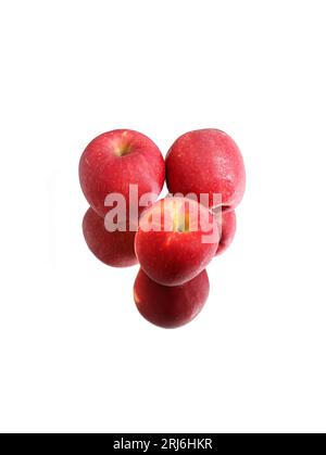 Closeup of two shiny red apples with stems on a white textured surface ...
