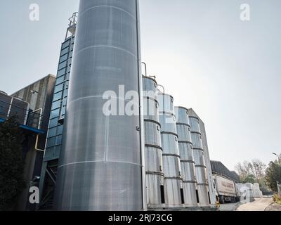 five silver/metallic silos beside each other. silo. tall silo Stock ...