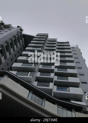 An elevated view of a contemporary high-rise building taken from ground ...