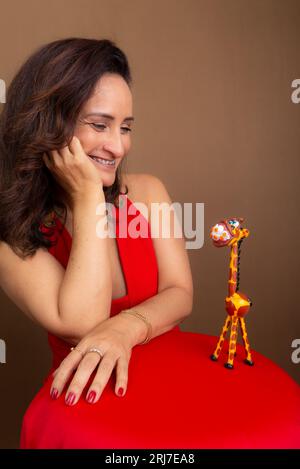 Cheerful coaching woman with a giraffe puppet. Symbol of non-violent ...