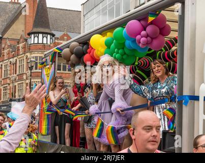Float in Lincoln Pride parade with people dressed in costume, High ...