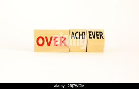 Achiever or overachiever symbol. Businessman turns wooden cubes and ...
