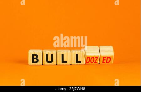 Bull or bulldozed symbol. Businessman turns wooden cubes and changes ...