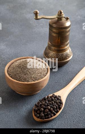 Black pepper grains, ground black pepper and metal mill ,top view Stock ...