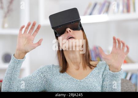 Girl in mask experiencing virtual reality as new entertainment device ...