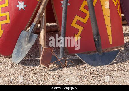Entrenching tools supported in shields. Digging tools used by ancient ...